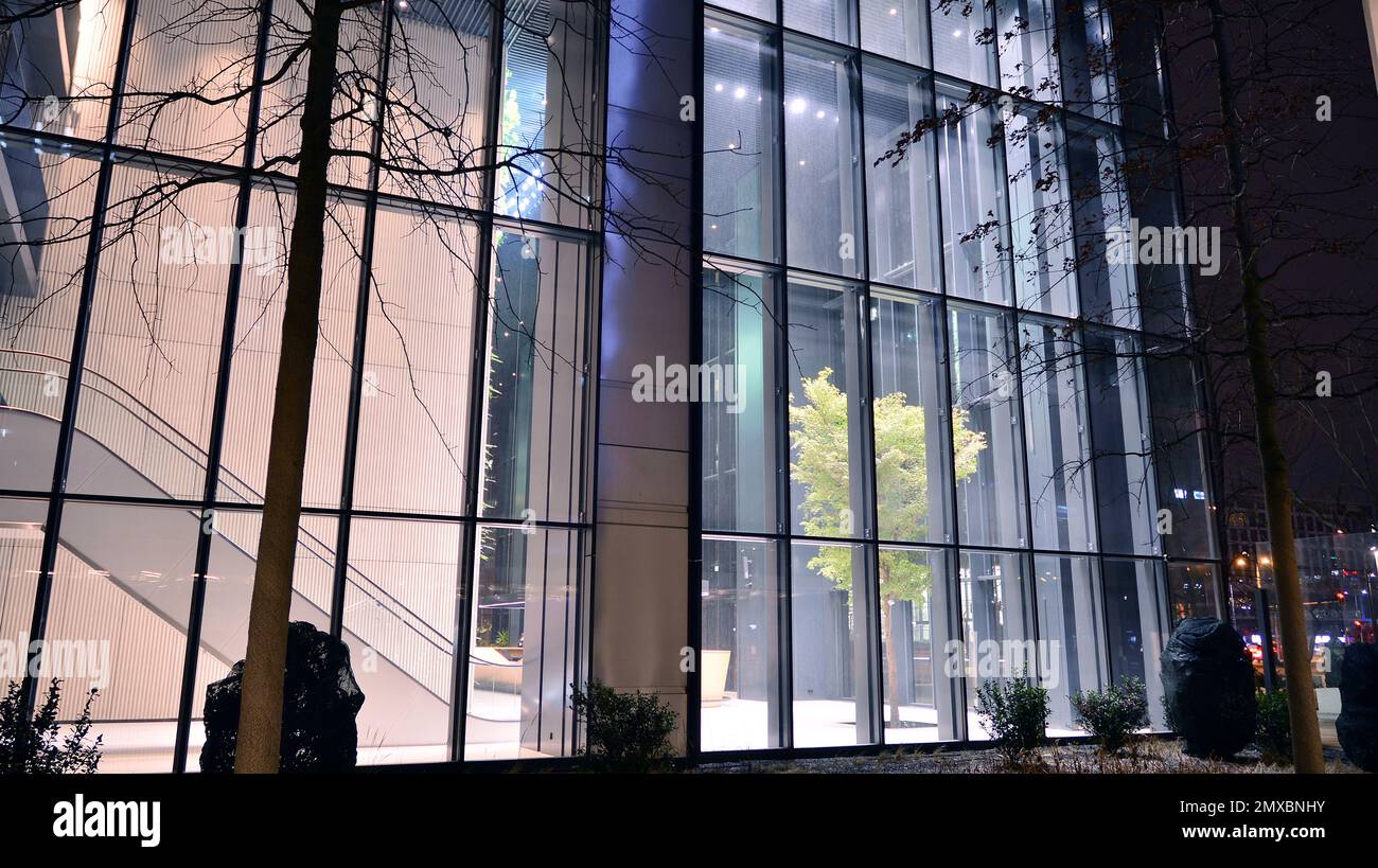 Night architecture, skyscraper with glass facade. Modern building in ...