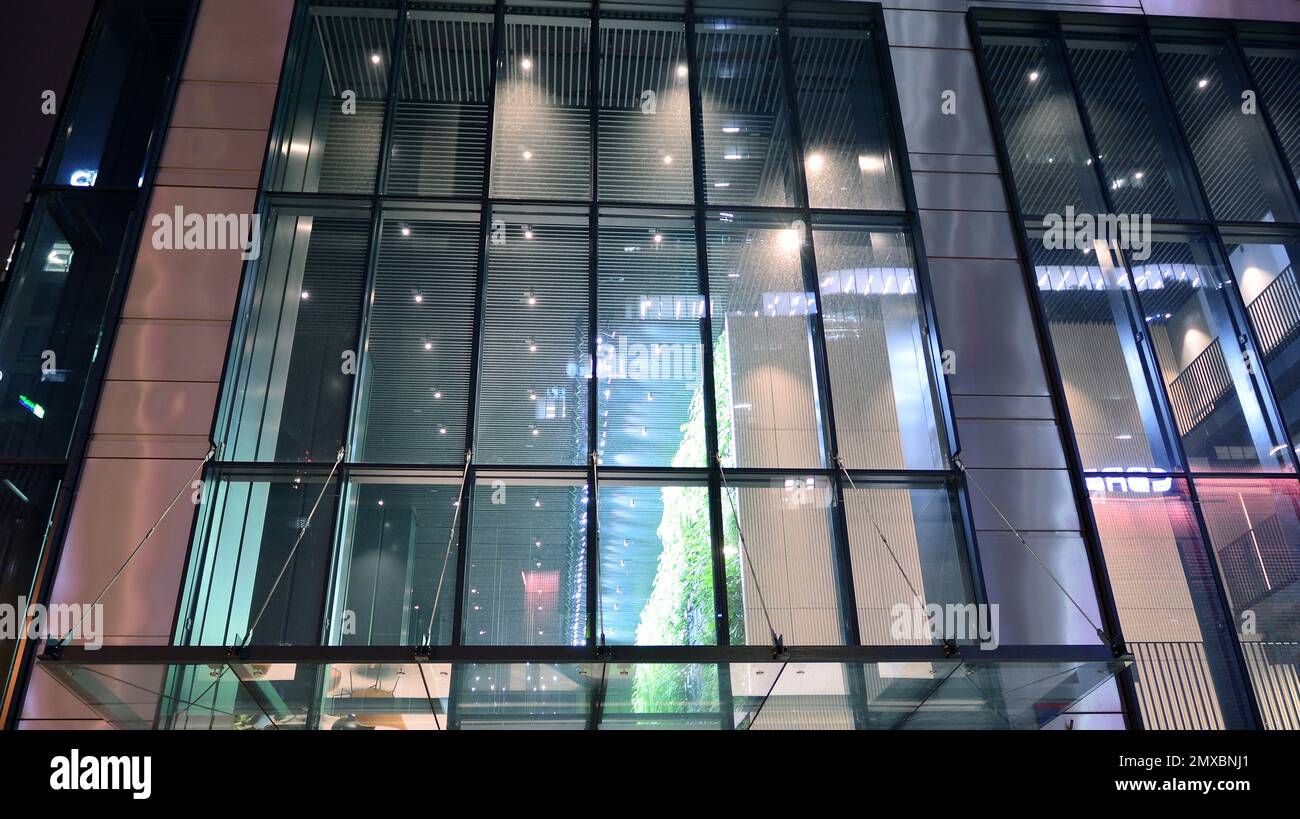 Night architecture, skyscraper with glass facade. Modern building in ...