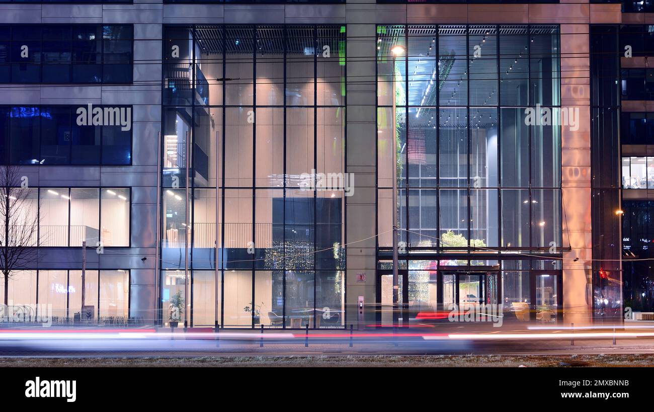 Night architecture, skyscraper with glass facade. Modern building in ...