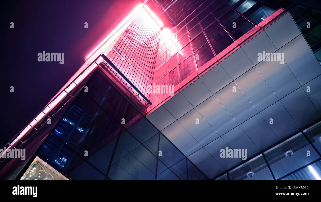 Amazing night cityscape. Office building at night, building facade with glass and lights. View ...