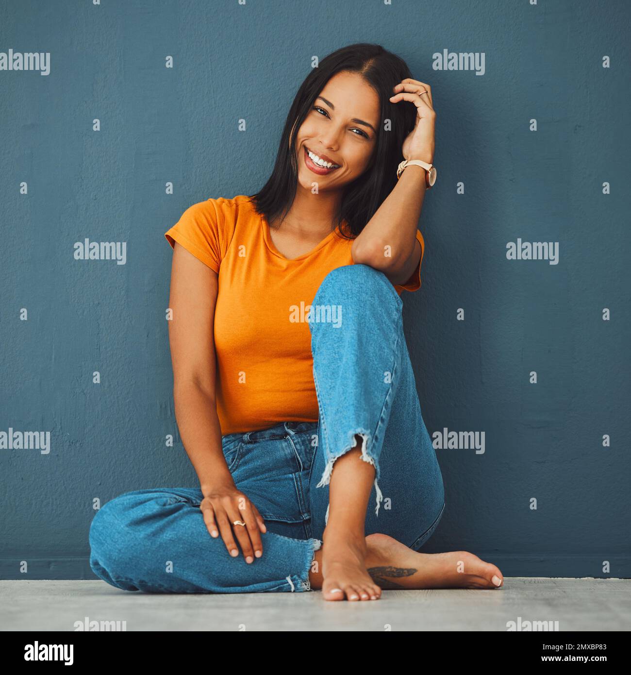Black woman, floor and home with smile by wall for clothes, relax and ...