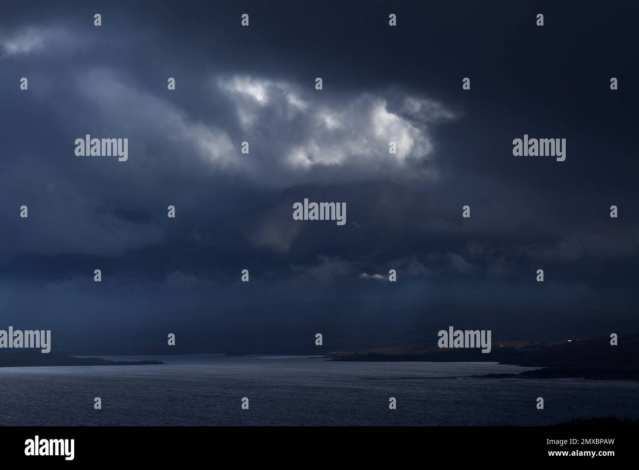 Cloudscape, nightfall in the Lapland mountains. Lake on this side and ...