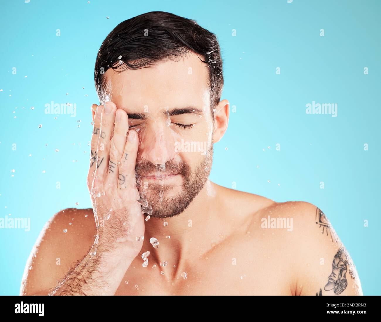 Water drop, skincare and man with hand on face, morning cleaning ...