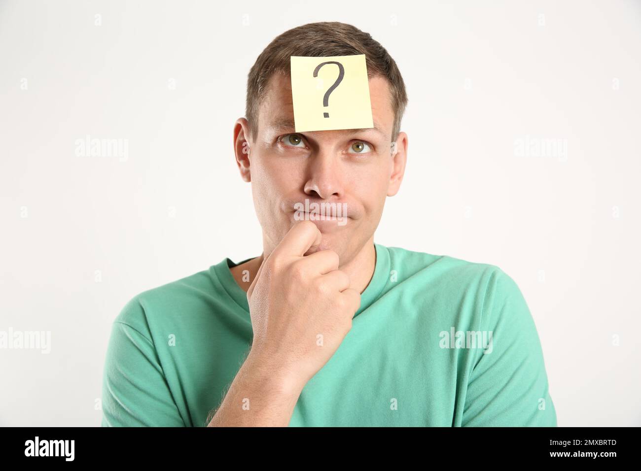 Thoughtful man with question mark on white background Stock Photo - Alamy