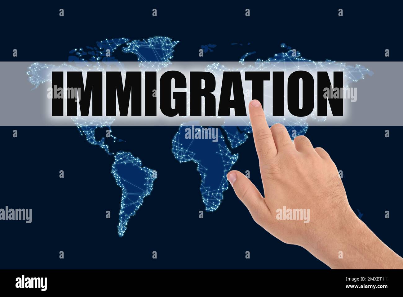 Man pointing at word IMMIGRATION and world map on dark blue background ...