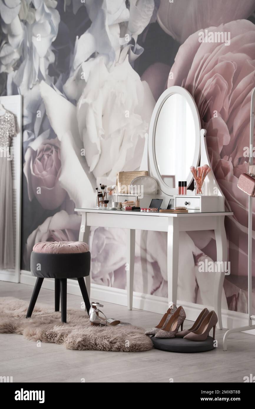 Stylish room interior with elegant dressing table and floral wallpaper ...