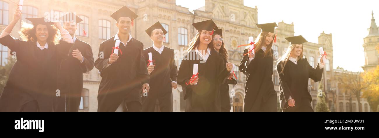 Happy students with diplomas near campus. Banner design Stock Photo - Alamy