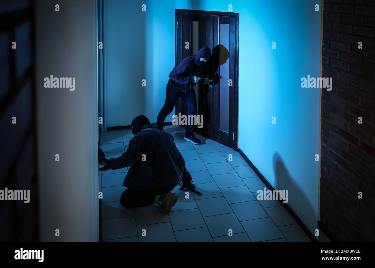 Dangerous criminals with gun and crow bar intruding into apartment ...