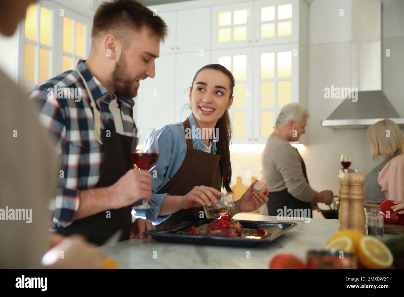 Happy people cooking food together in kitchen Stock Photo - Alamy