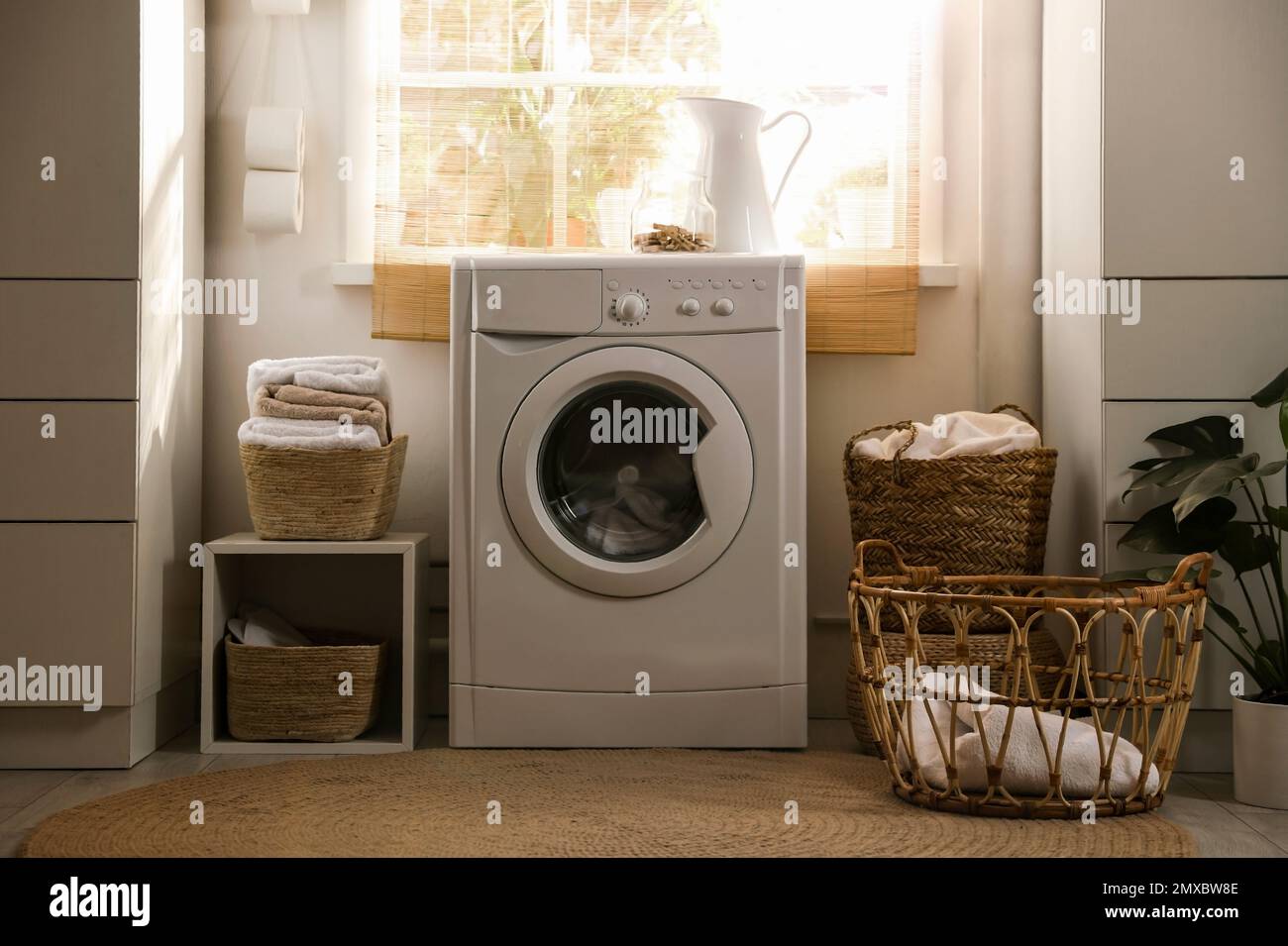 Stylish room interior with washing machine. Design idea Stock Photo - Alamy