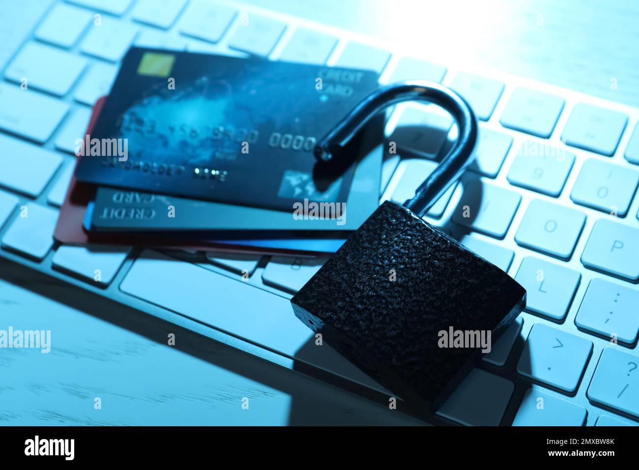 Credit cards, lock and computer keyboard on table, closeup. Cyber crime ...
