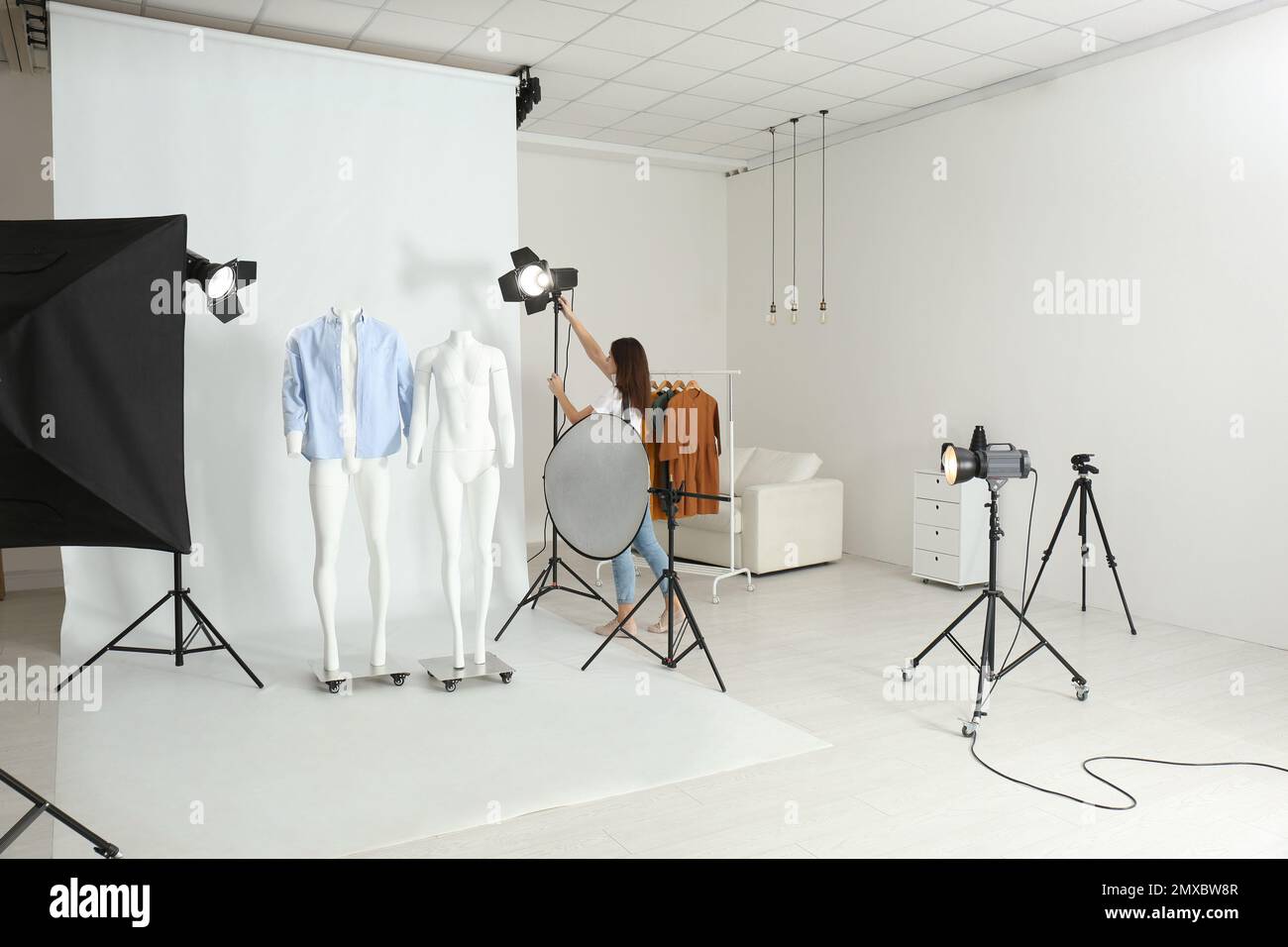 Ghost mannequins with modern clothes and professional photographer ...