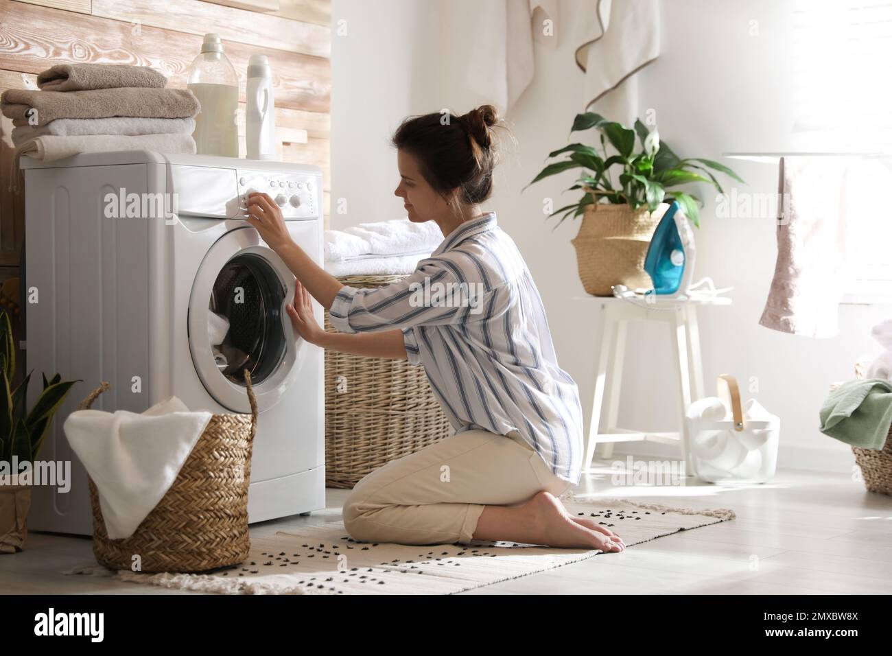 Woman using washing machine hi-res stock photography and images - Alamy
