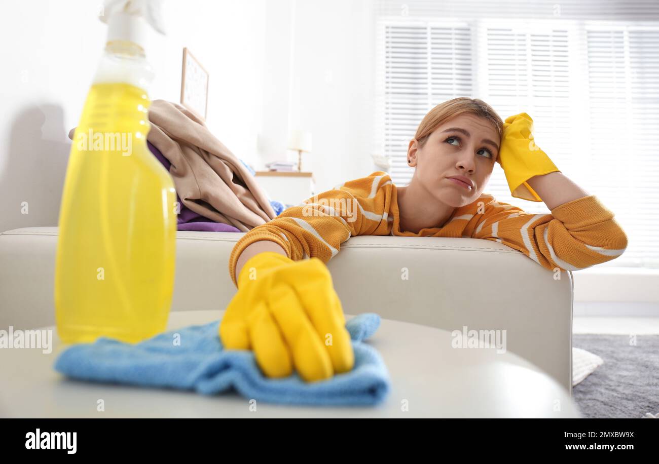 Lazy young woman wiping table at home. Cleaning and housework Stock ...