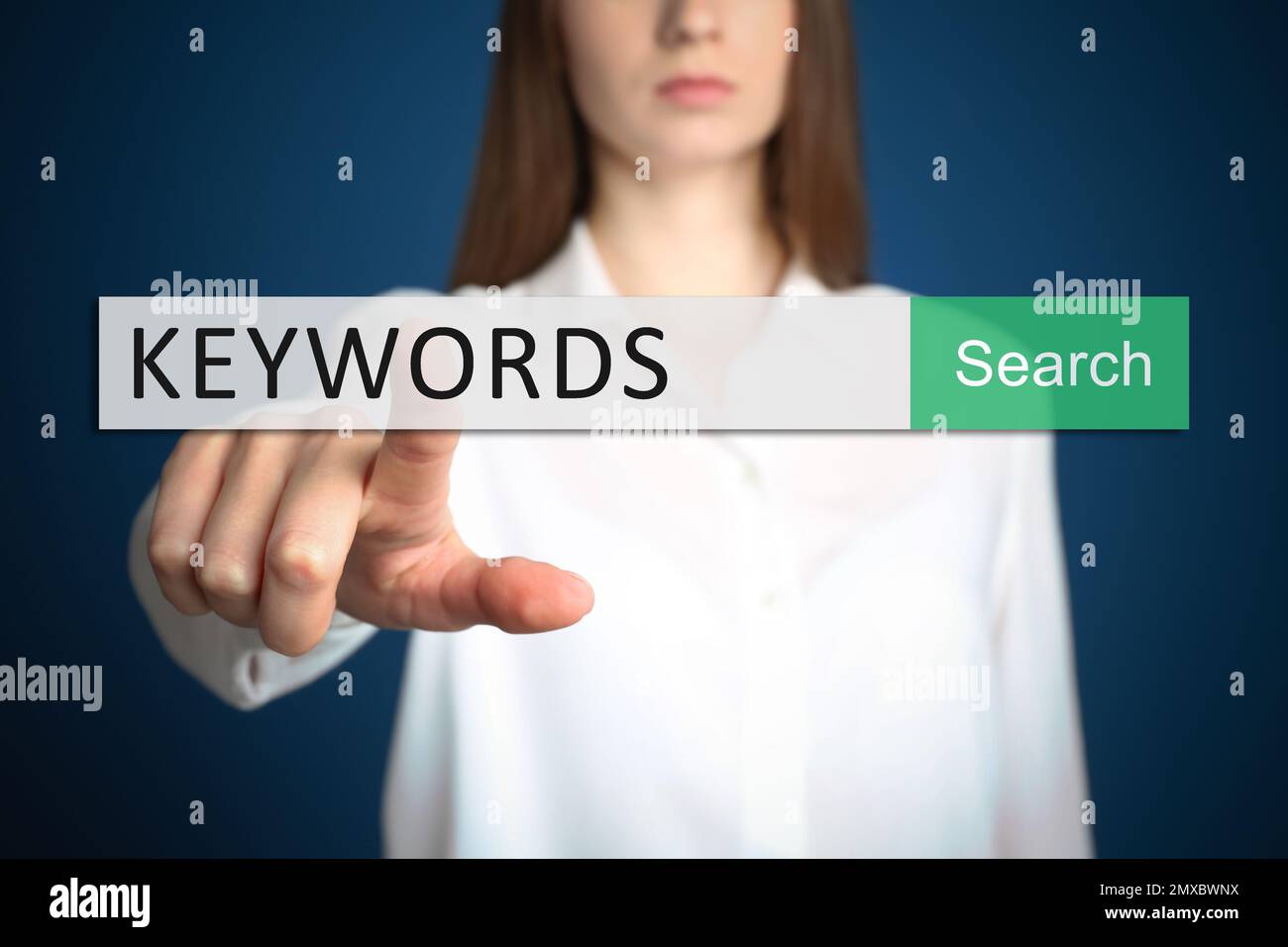 Woman pointing at search bar with text KEYWORDS on blue background ...