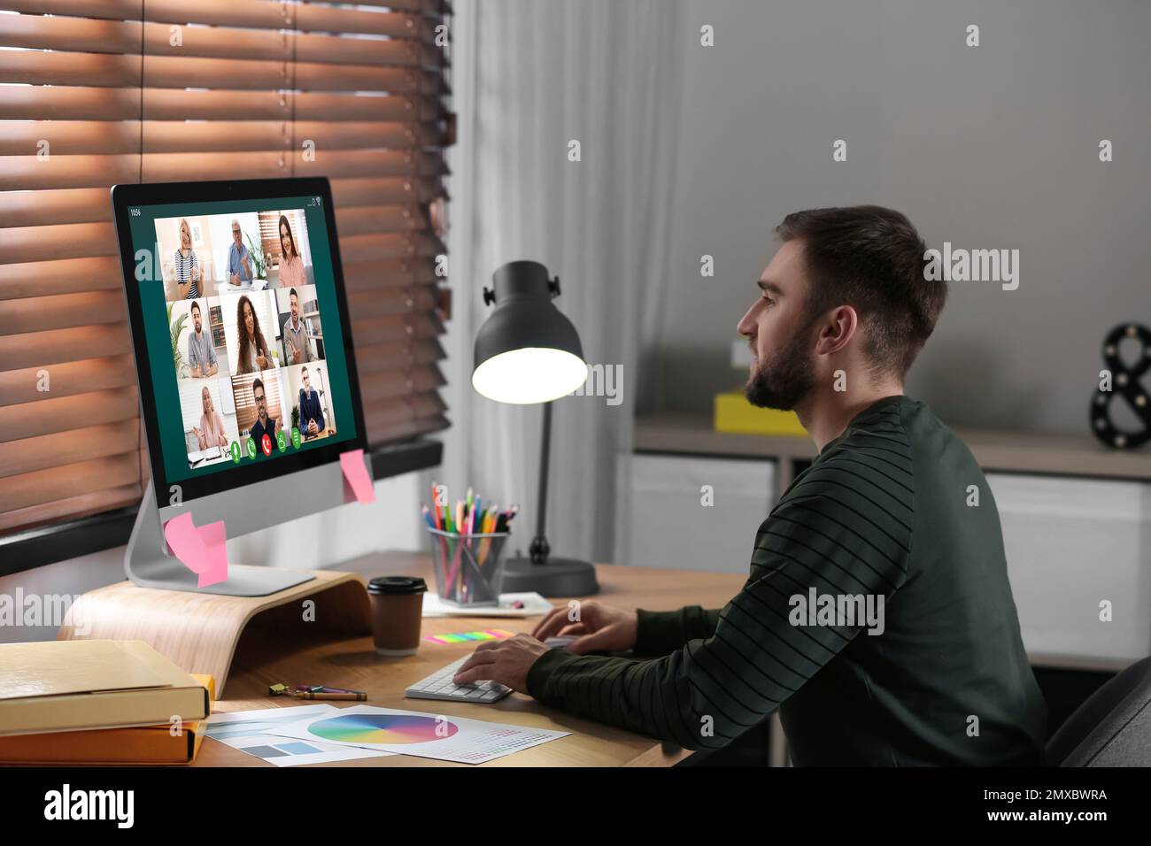 Man having video chat with colleagues at table in office. Team work ...