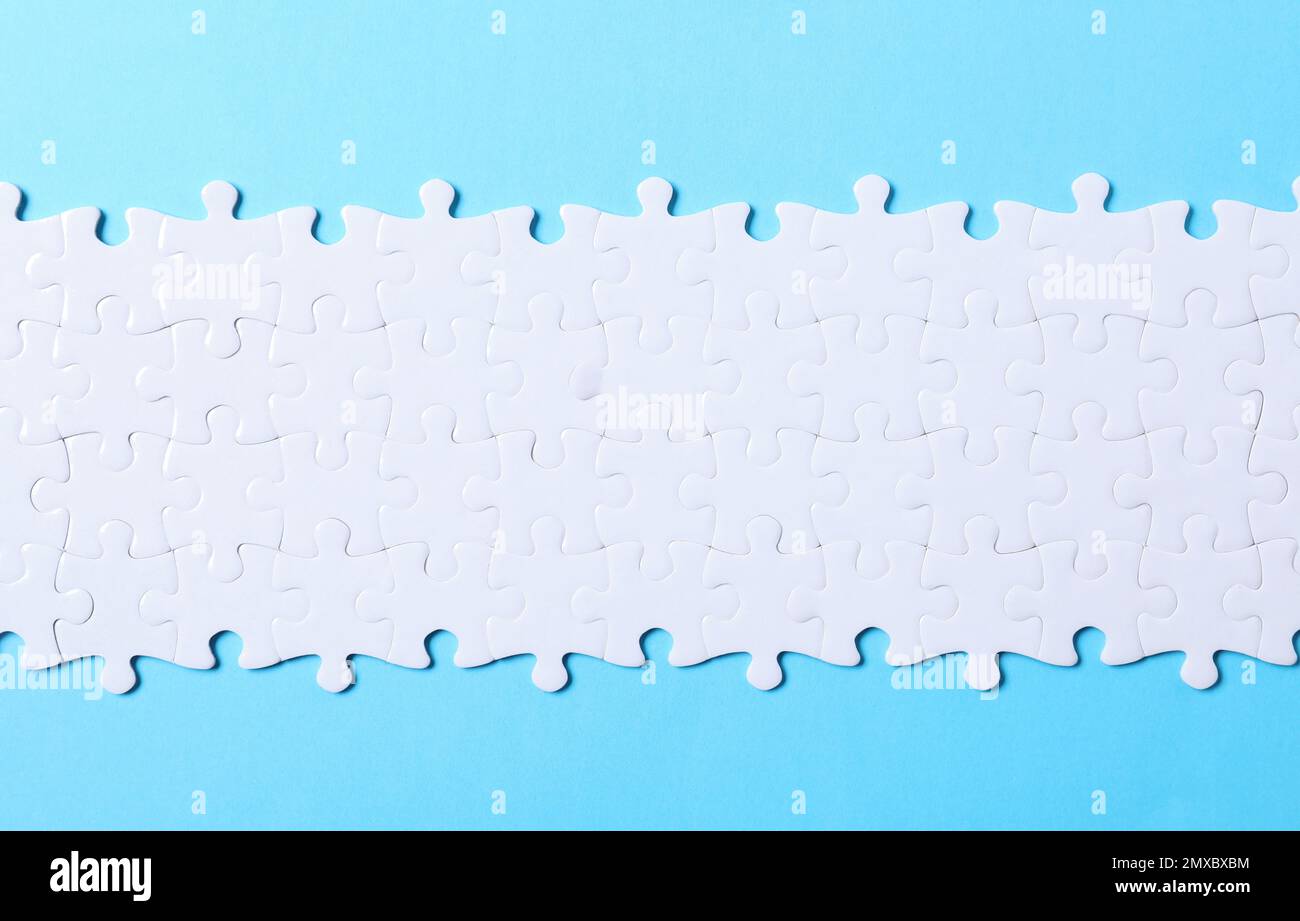 Blank white puzzle light blue background, top view Stock Photo - Alamy