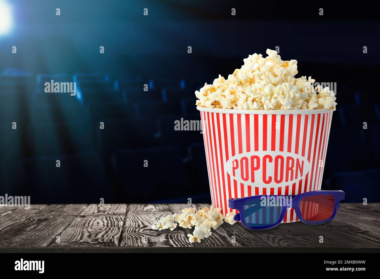 Popcorn, 3D glasses in cinema on table and empty cinema hall, space for text Stock Photo - Alamy