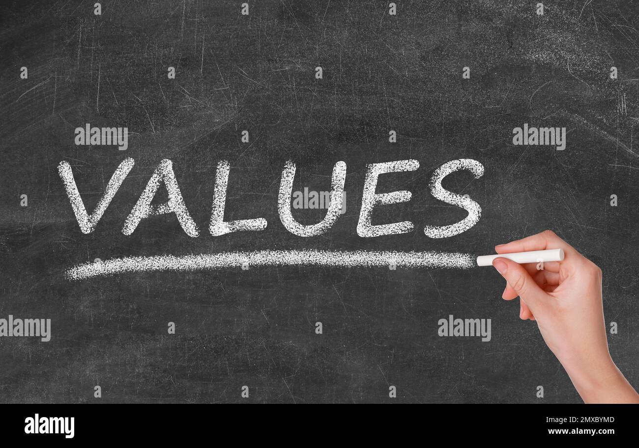 Woman writing word VALUES on blackboard, closeup Stock Photo - Alamy