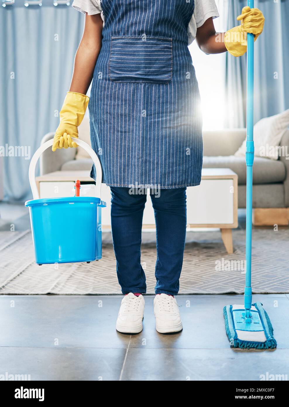 Cleaning, bucket and mop with feet of women in living room for hygiene ...