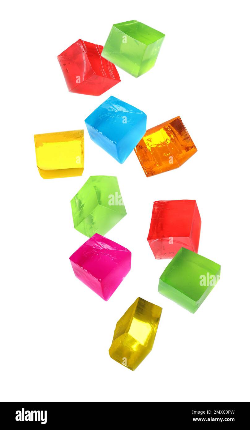 Set of different delicious jelly cubes falling on white background ...