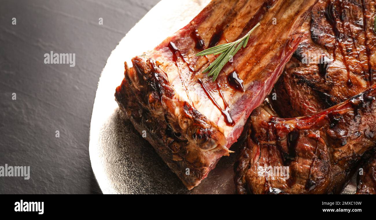 Delicious grilled ribs with rosemary on table, closeup. Banner design ...