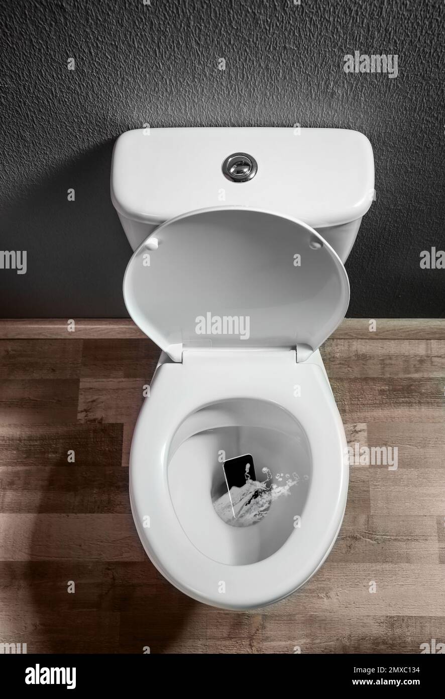 Smartphone dropped into toilet bowl indoors, top view Stock Photo - Alamy