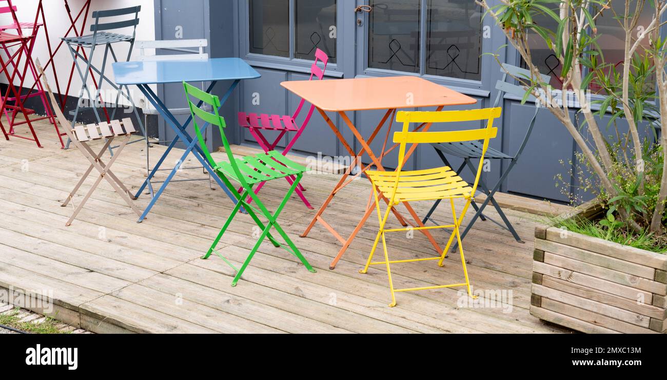 colorful metal chairs and table on empty terrace at cafe in web banner ...