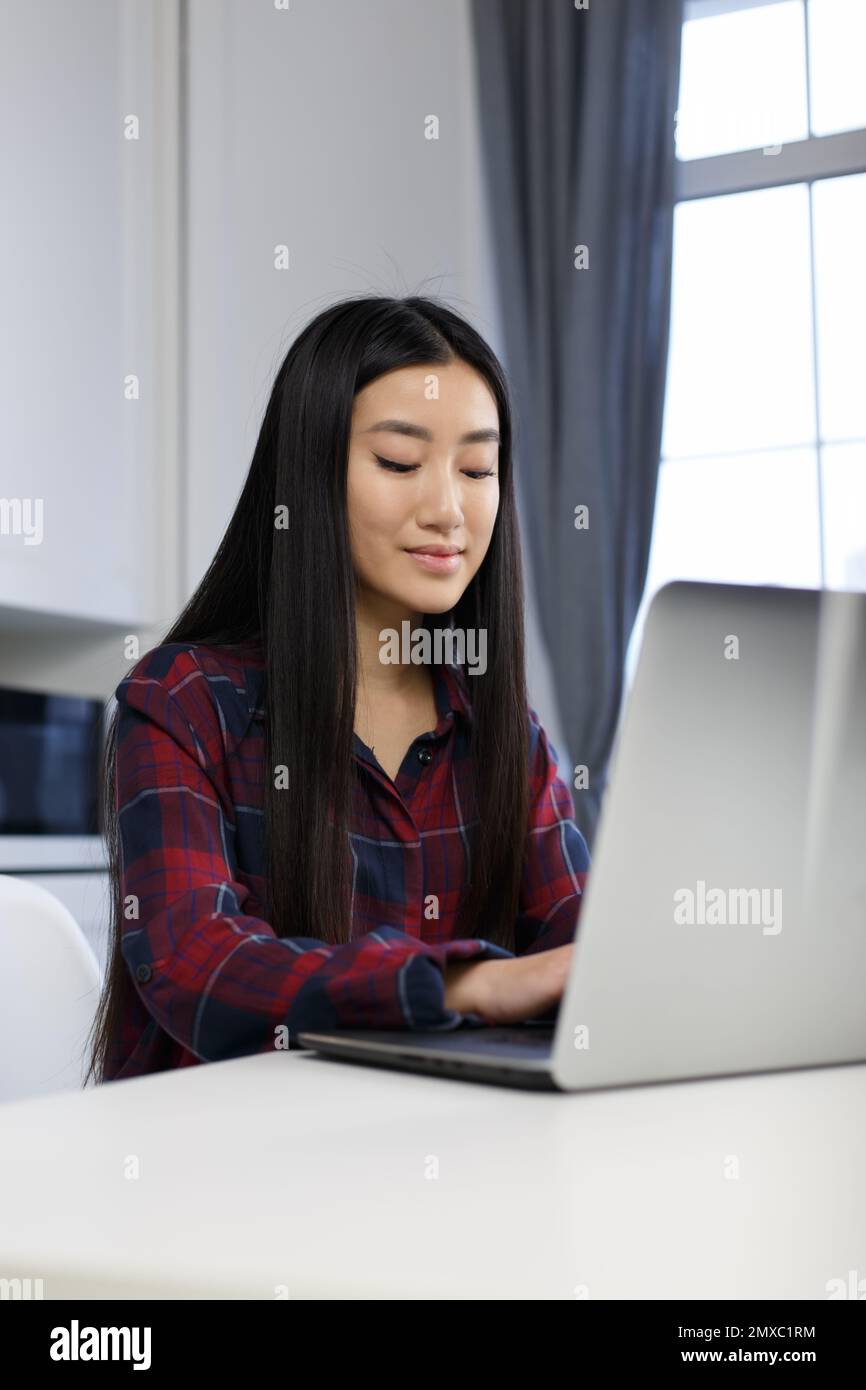 Beautiful Vietnamese girl using laptop computer for studying online ...
