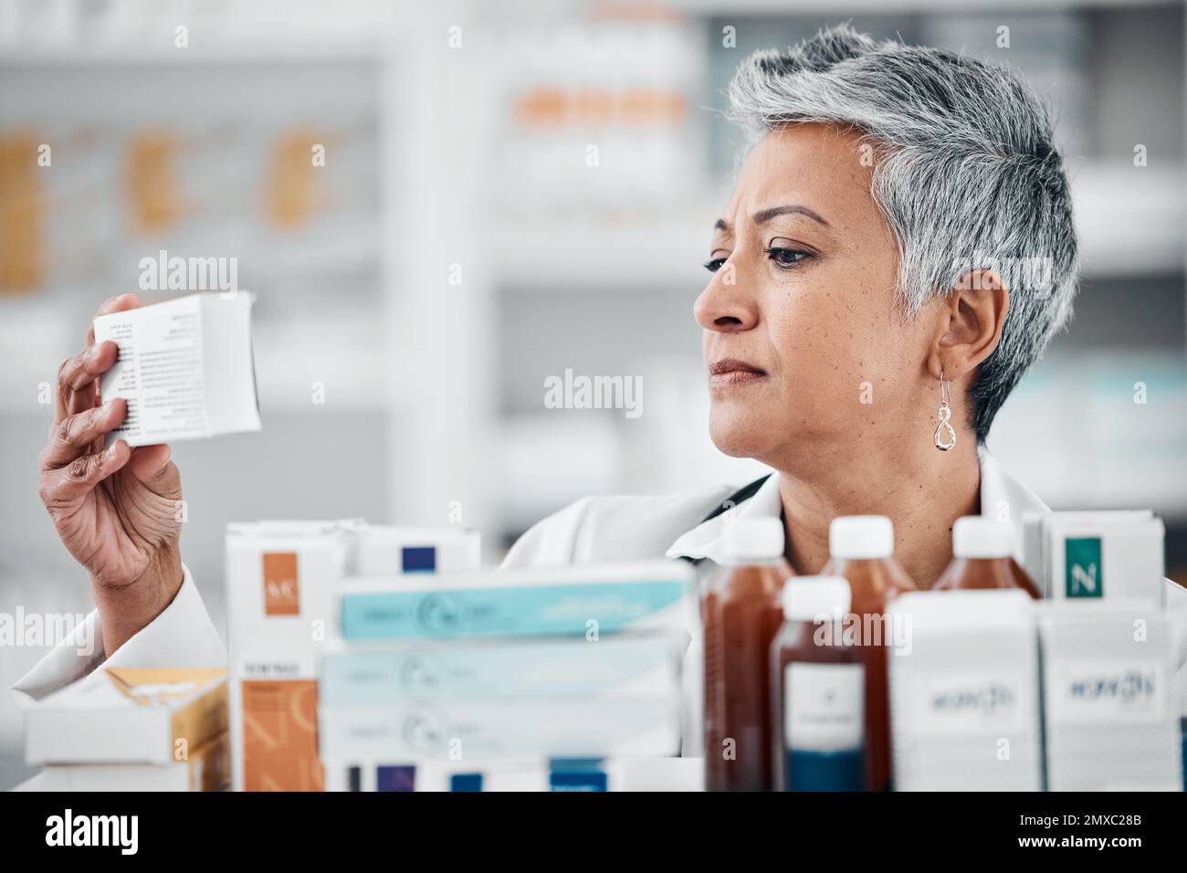 Pharmacy, stock and senior woman pharmacist with box, pills and ...