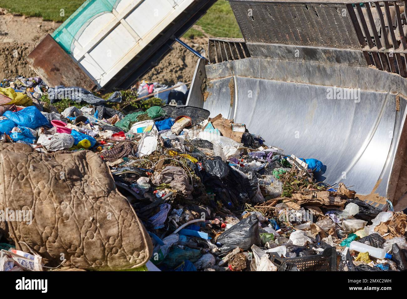 Heavy machinery shredding garbage in an open air landfill. Waste Stock ...