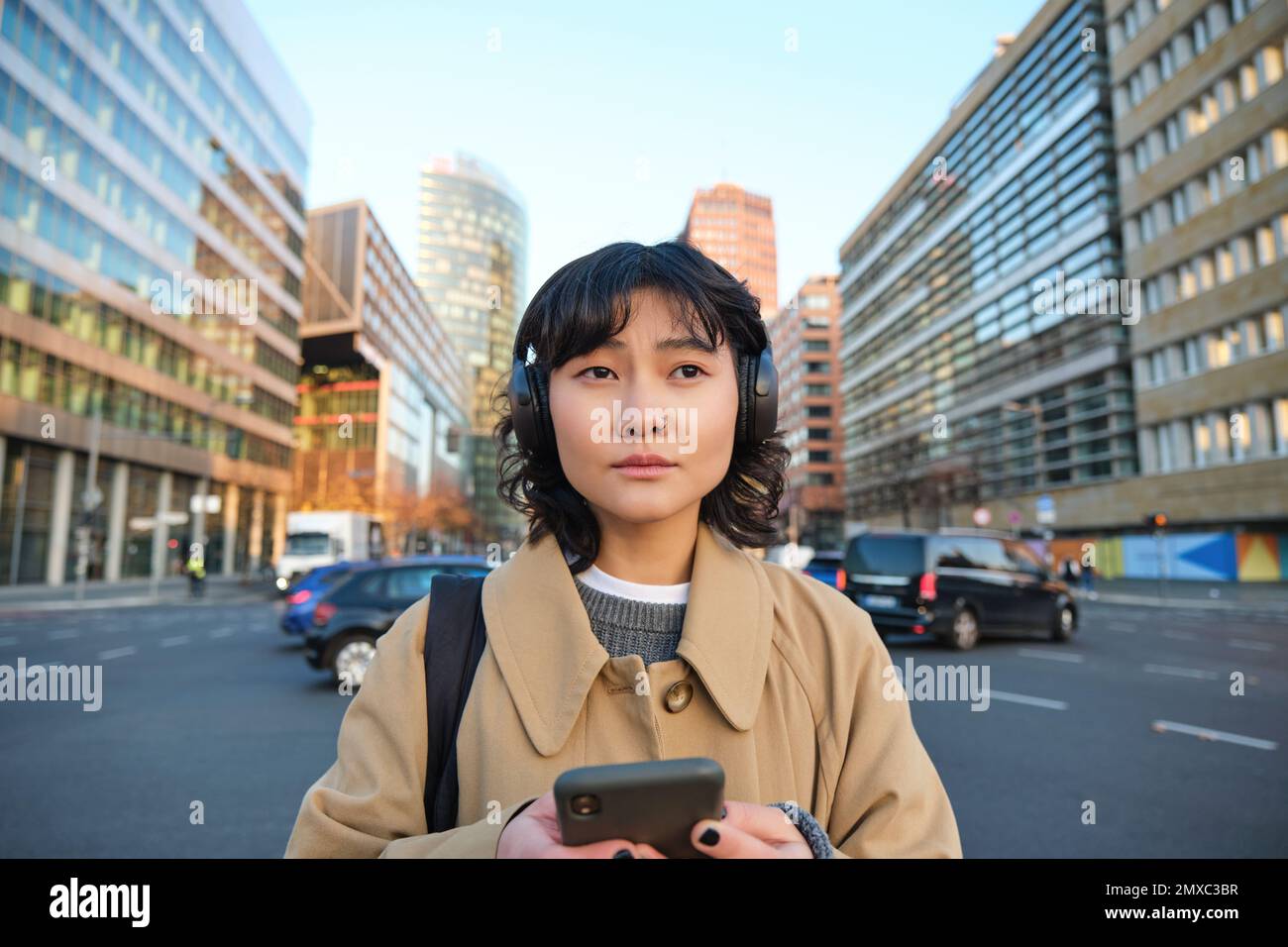 Portrait of concerned girl standing on street of city. Young korean ...