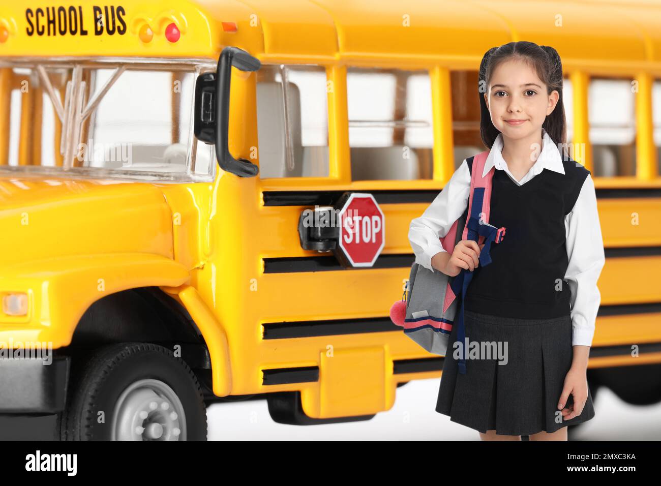 Girl with backpack near yellow school bus. Transport for students Stock ...