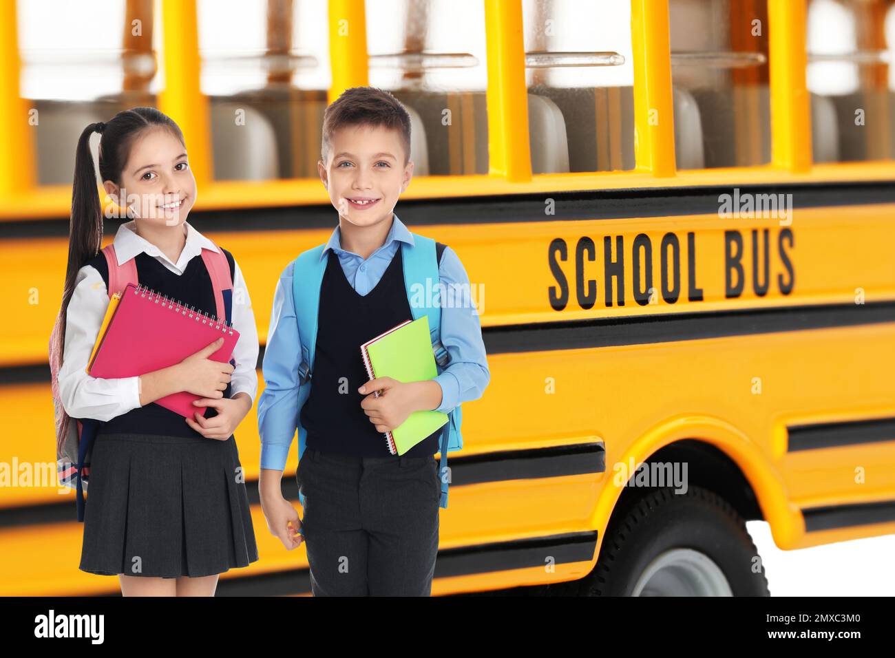 Children with backpacks near yellow school bus. Transport for students ...