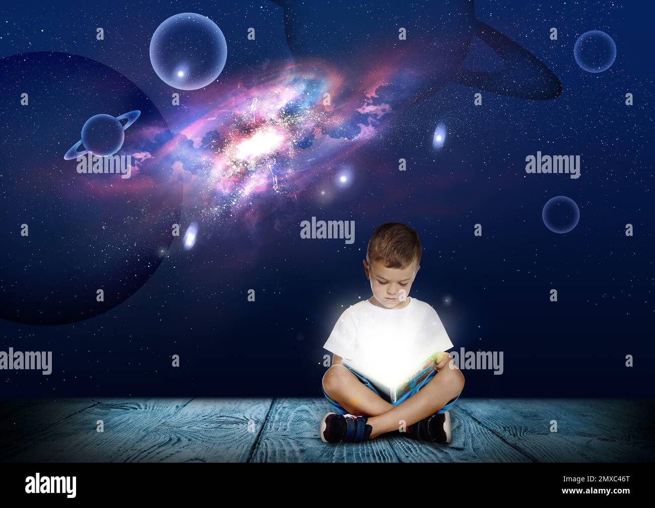 Cute little boy reading magic book. Night sky with stars and planets on ...