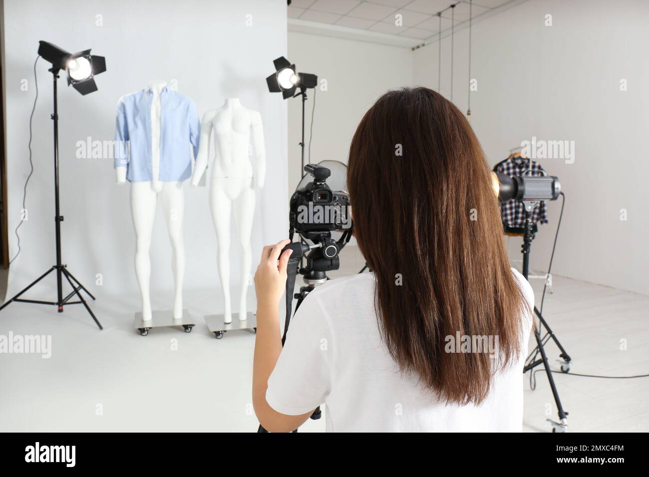 Professional photographer taking picture of ghost mannequins with ...