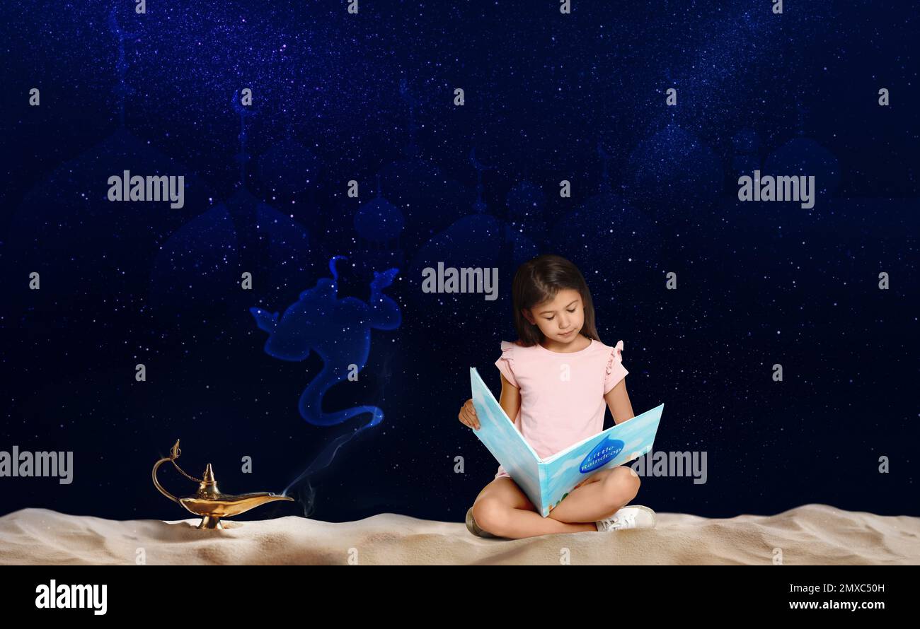 Cute little girl reading magic book and Aladdin magic lamp on sand at ...