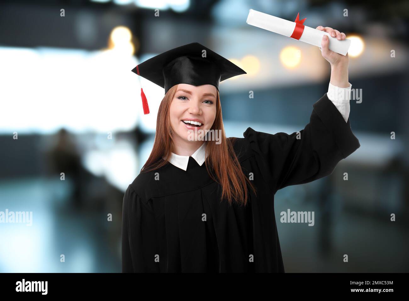 Happy student with graduation hat and diploma in office Stock Photo - Alamy