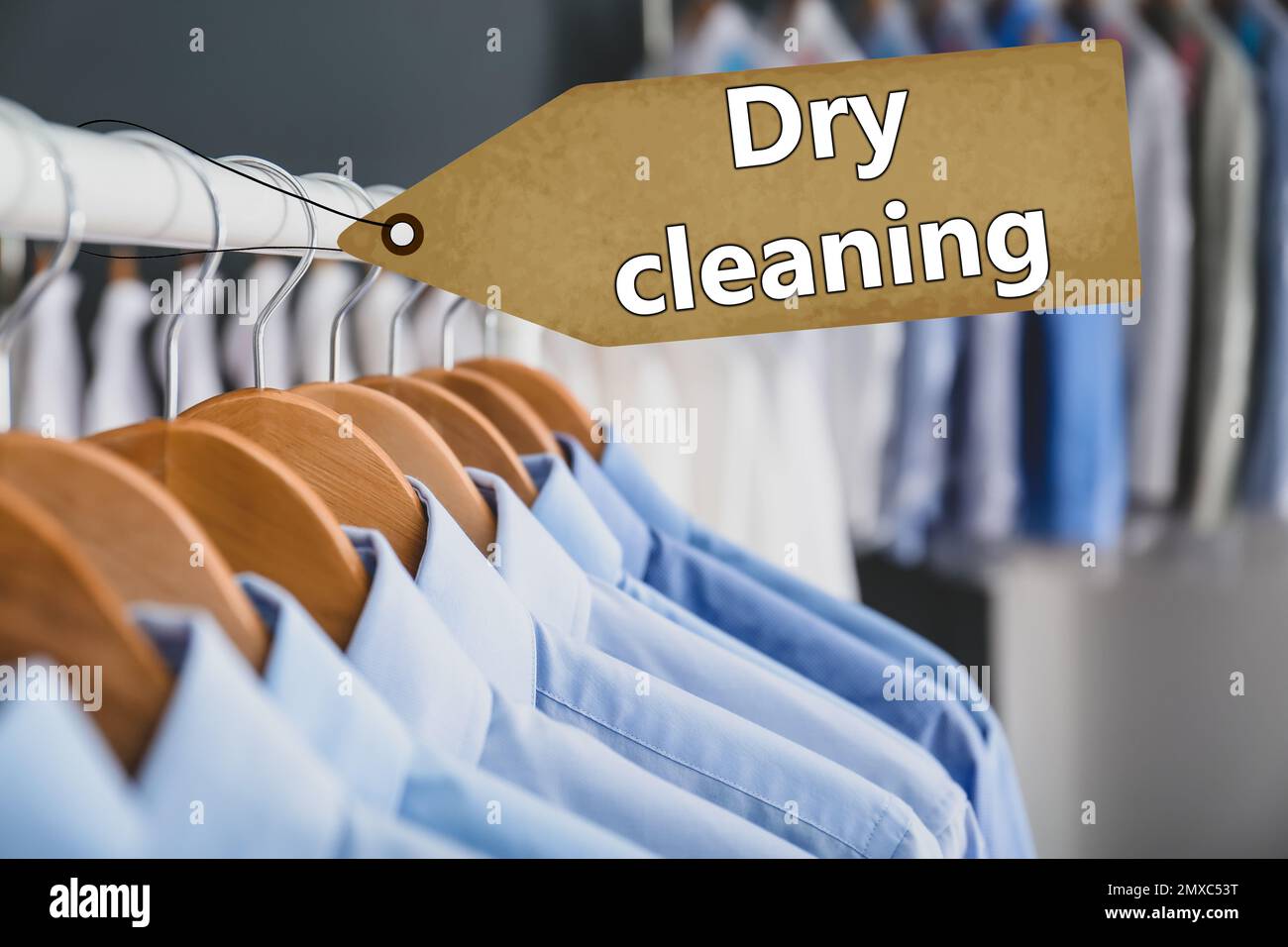 Rack with clean clothes on hangers after dry-cleaning indoors Stock ...