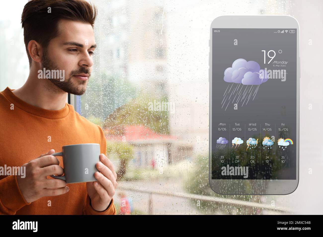 Thoughtful handsome man near window indoors and smartphone with open ...