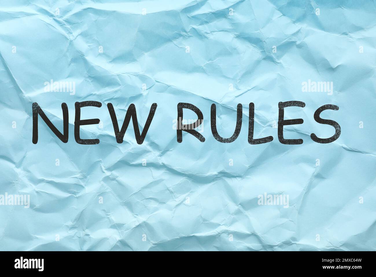 Text NEW RULES on sheet of color crumpled paper Stock Photo - Alamy