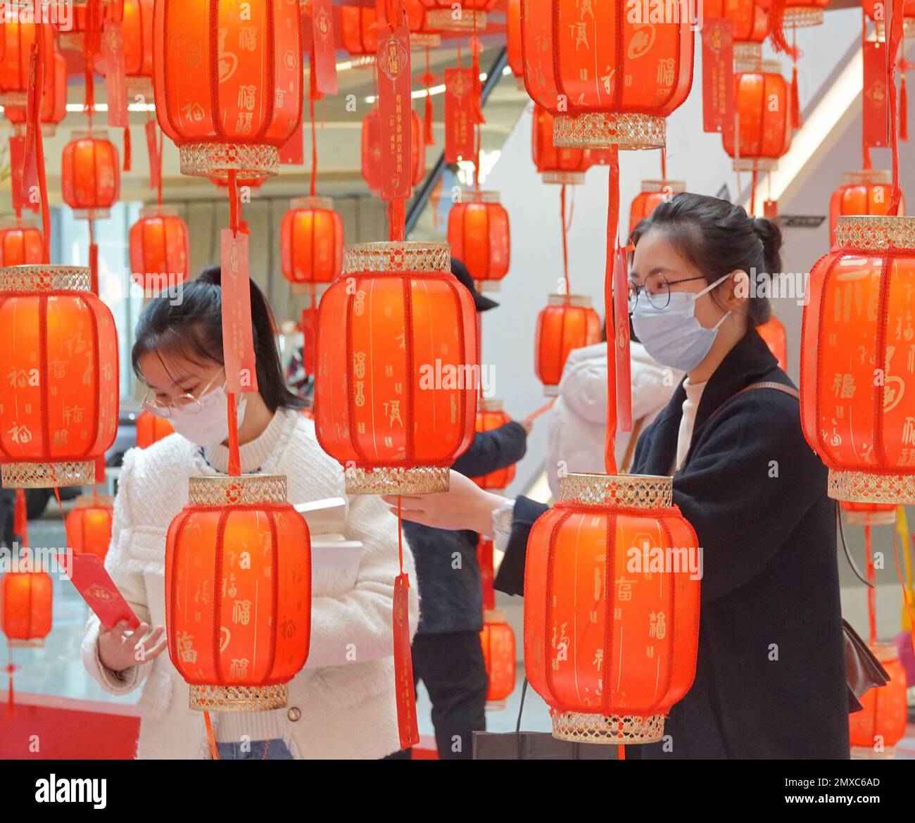 YANTAI, CHINA - FEBRUARY 3, 2023 - People guess lantern riddles at a ...