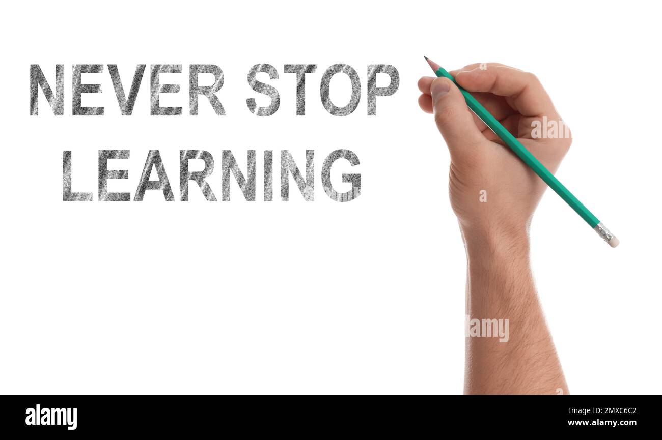 Man writing phrase NEVER STOP LEARNING on white background, closeup ...