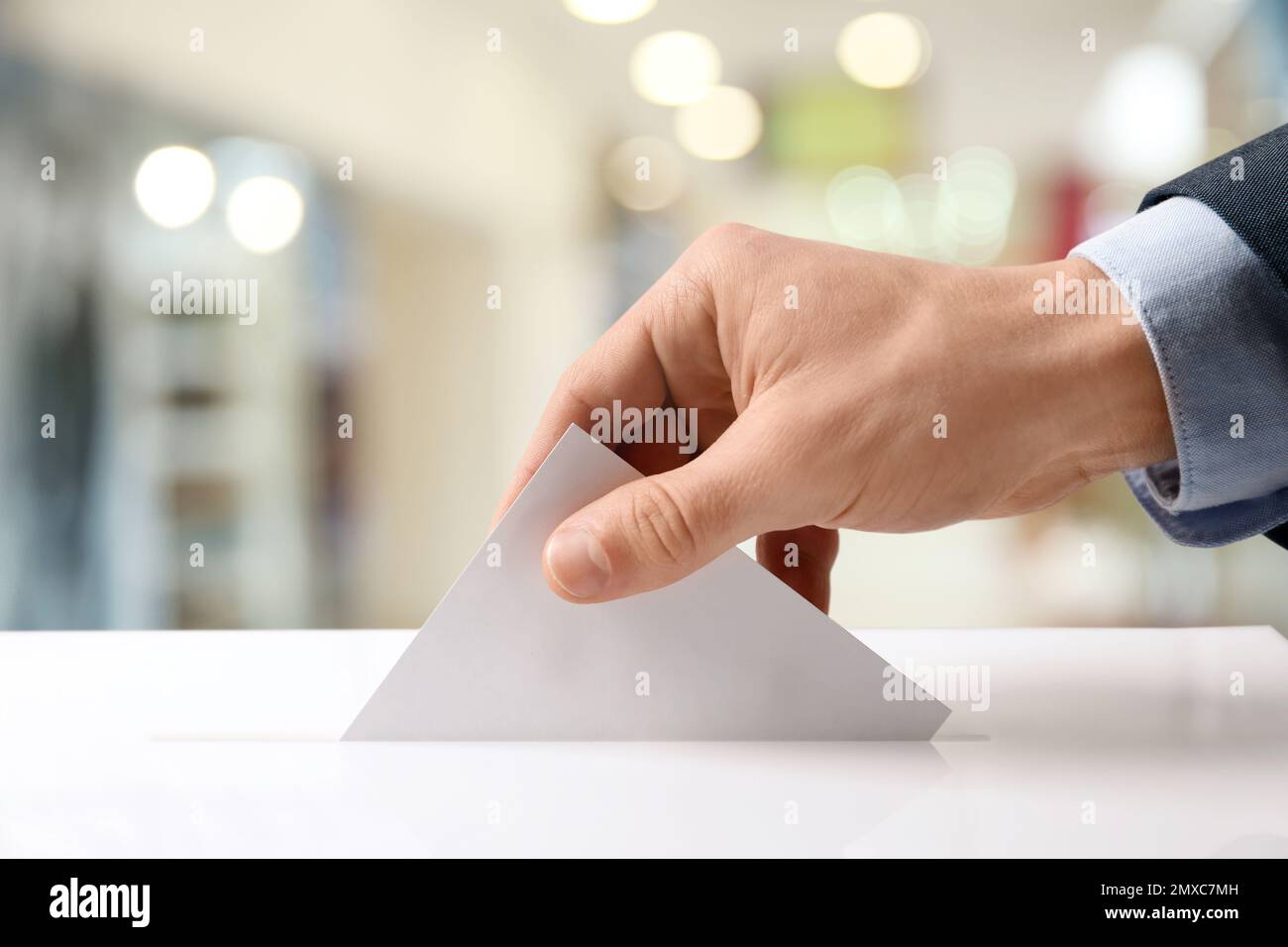 Man putting his vote into ballot box indoors, closeup Stock Photo - Alamy