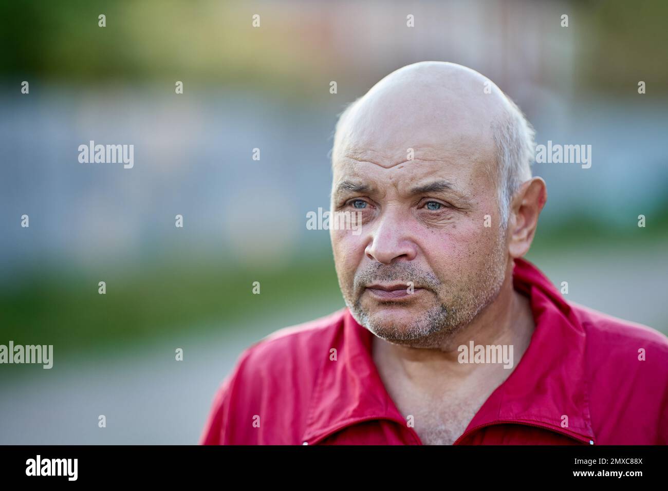 Baldheaded man in his 60s looks ahead sadness Stock Photo - Alamy