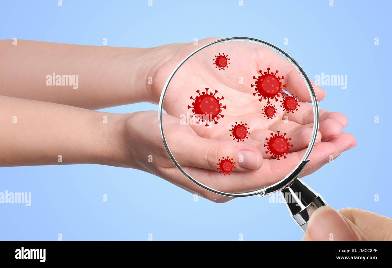 Woman detecting bacteria with magnifying glass on blue background ...