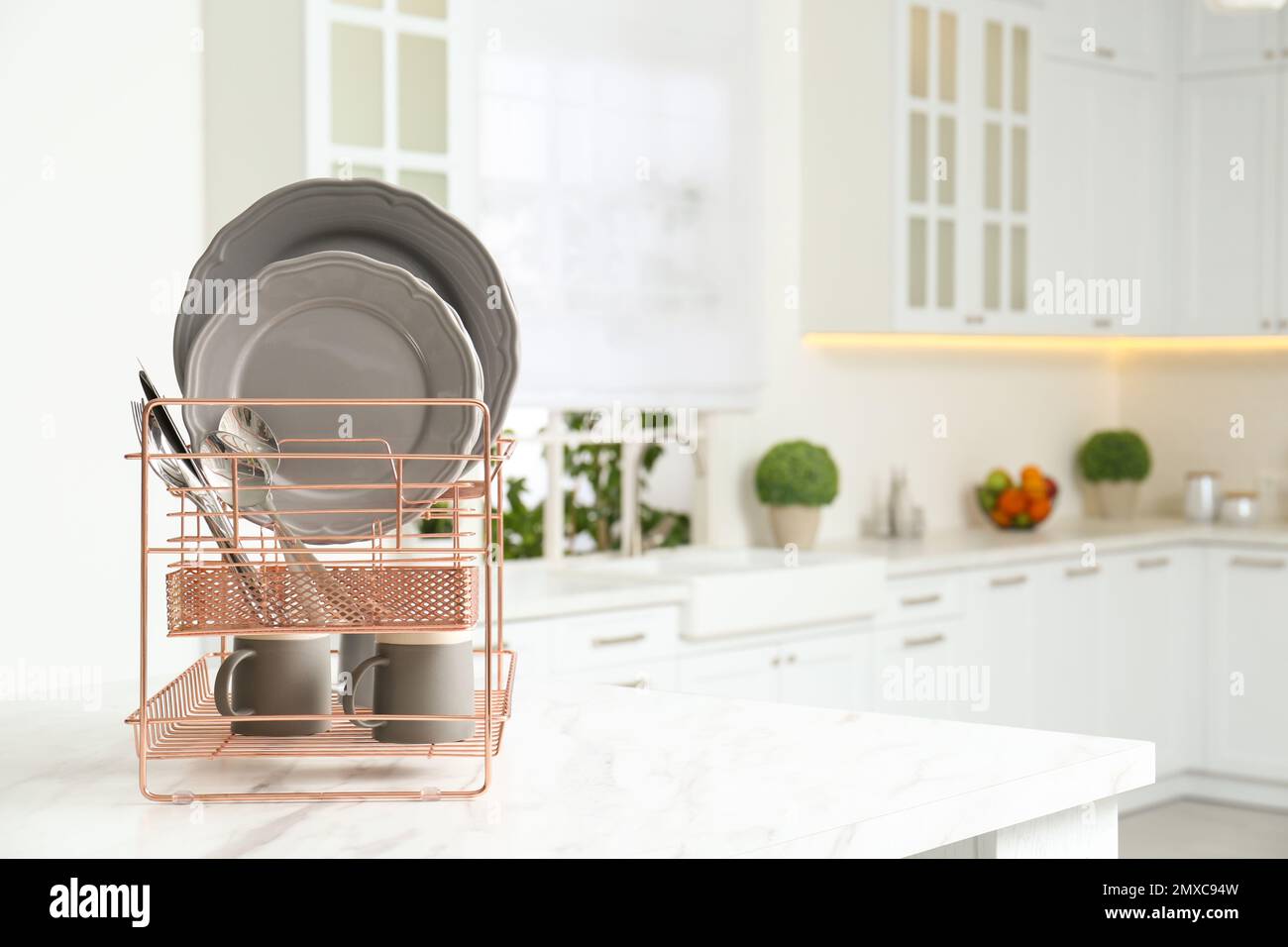 Drying rack with clean dishes on table in kitchen. Space for text Stock ...