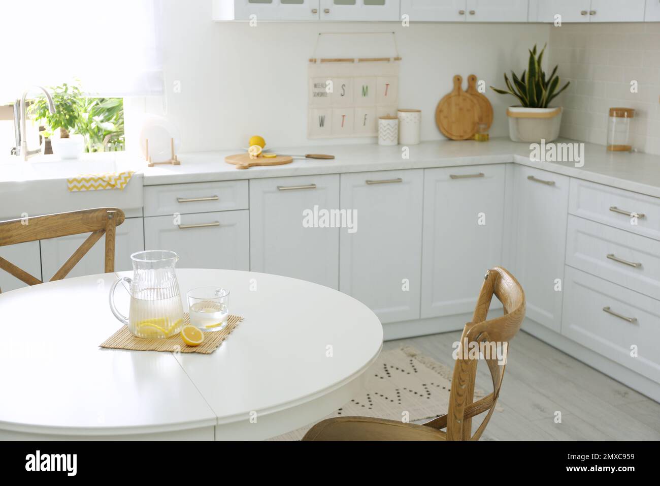 Lemonade on white table in modern kitchen. Interior design Stock Photo ...
