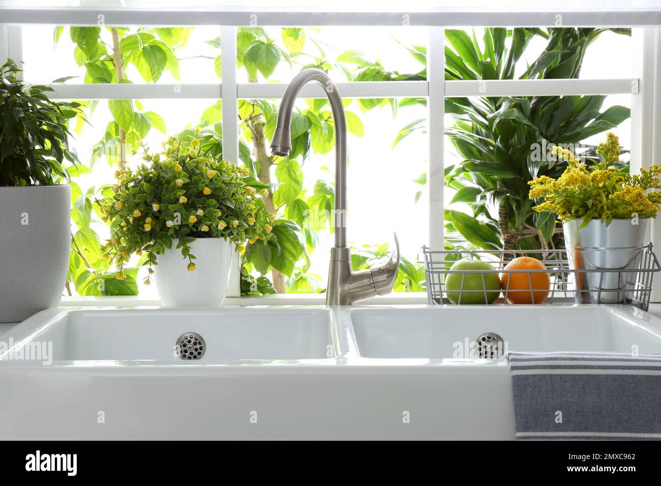 Beautiful white sink near window in modern kitchen Stock Photo - Alamy