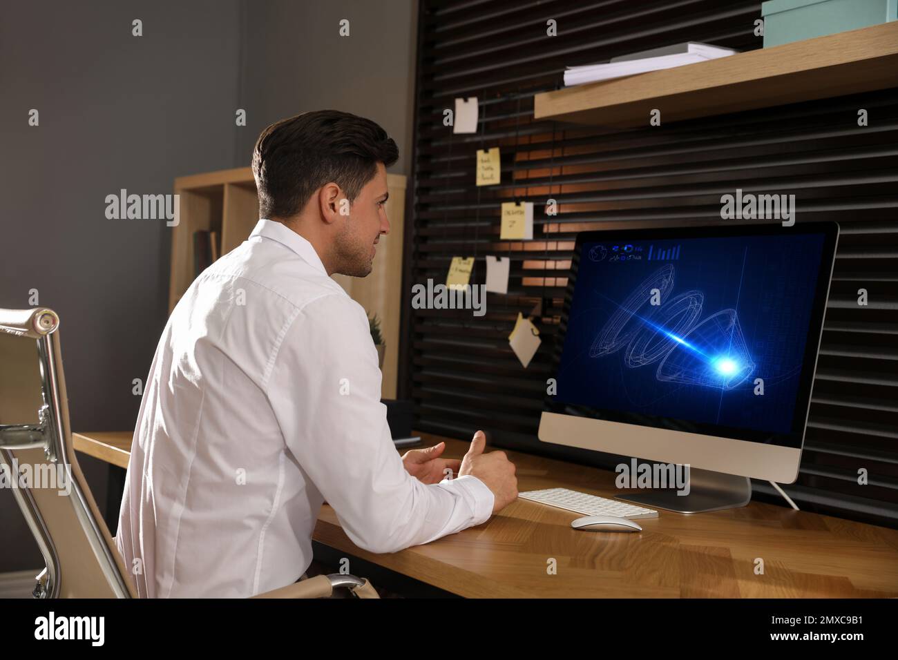 Male engineer working with 3d model of modern equipment on computer in ...